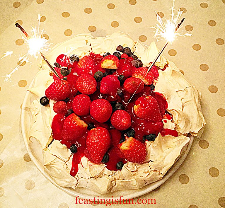 Raspberry Coulis Drizzled Mixed Berry Pavlova - Feasting Is Fun